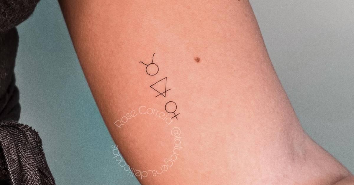 Minimalistic style symbols tattooed on the inner arm.