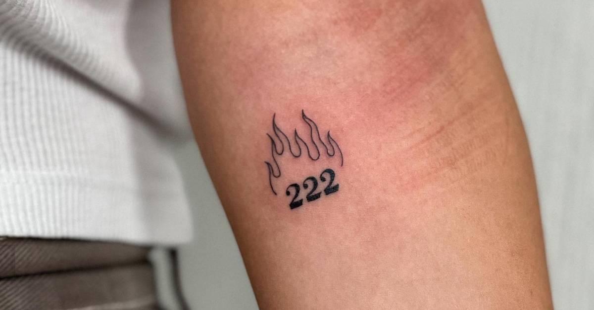 Tattoo of the number "222" and fire tattooed on the