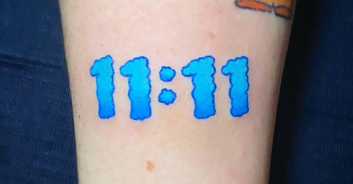 Hand poked angel number "11:11" tattoo located on the