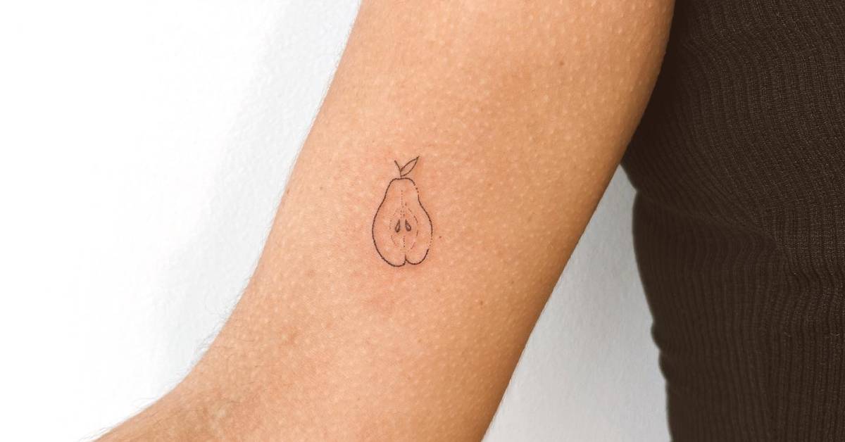 Cute fine line pear tattoo located on the inner arm.