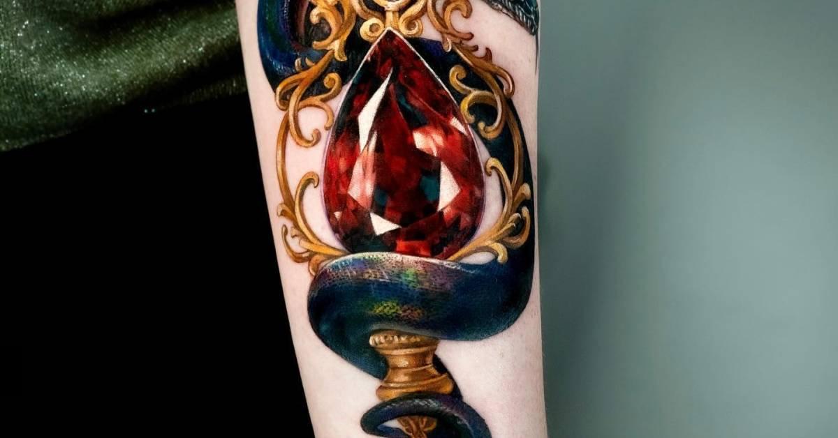 Realistic style ruby and snake tattoo located on the