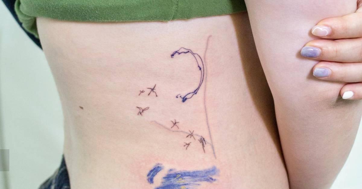 Abstract sea, stars and moon tattoo located on the rib.