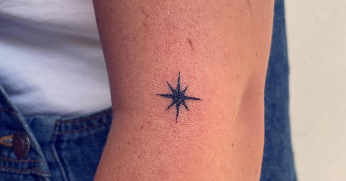 Minimalistic star tattoo hand poked on the elbow.