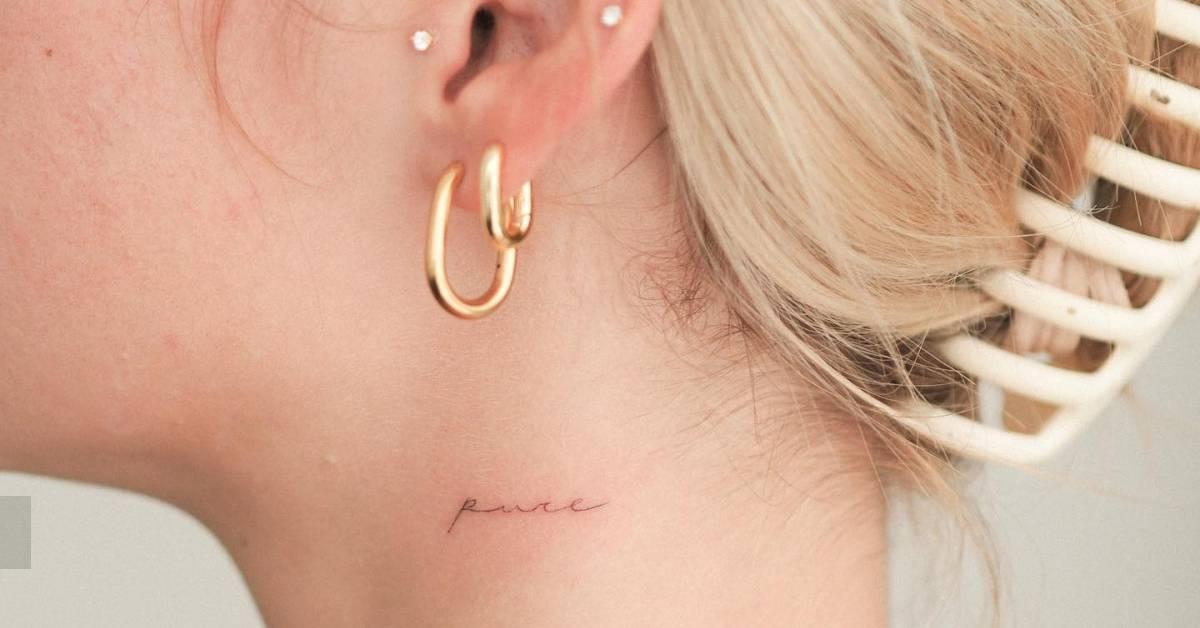 Lettering tattoo of the word "pure" handwritten on the