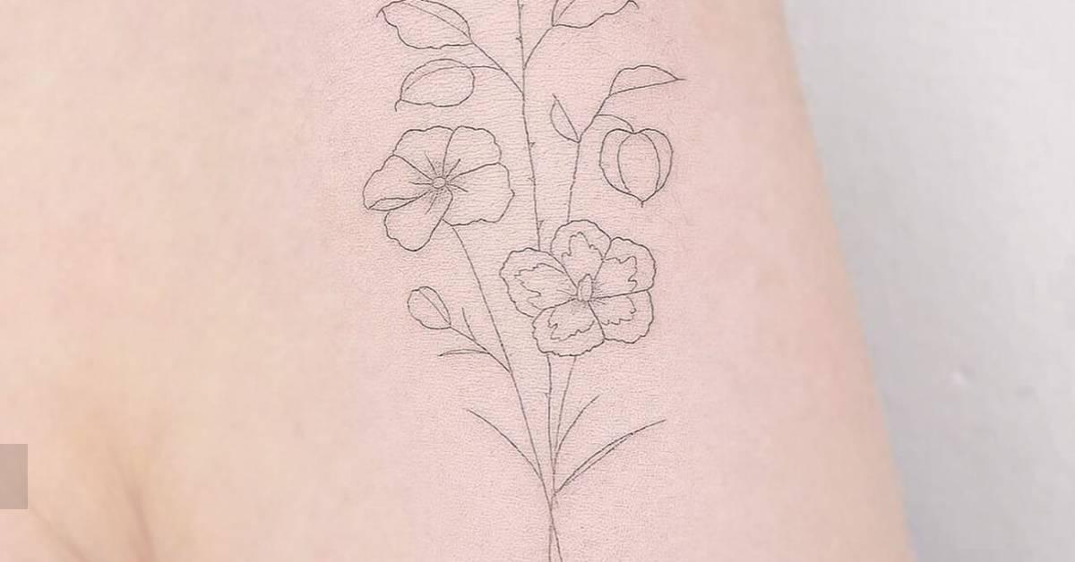 Fine line style flower bouquet tattoo located on the
