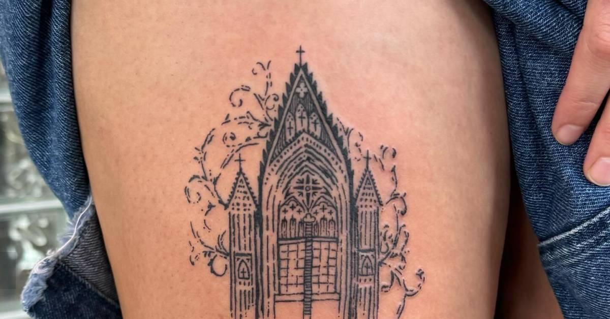 Blackwork style church tattoo located on the thigh.