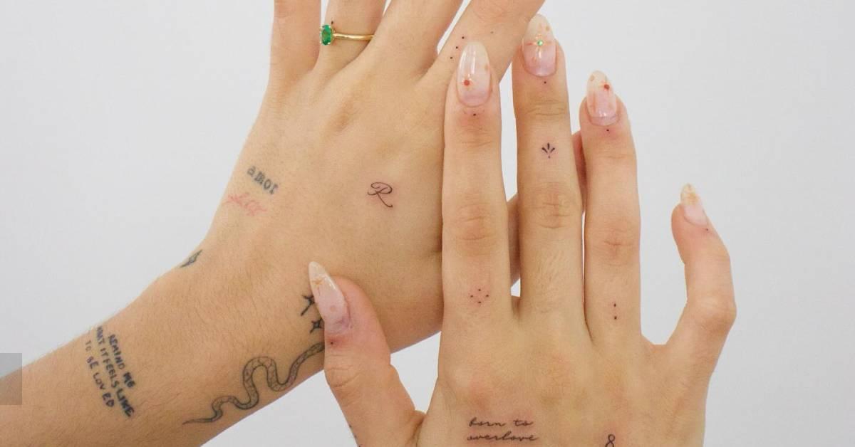 Fine line style hand composition tattoos.