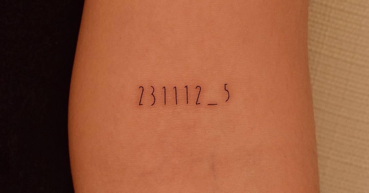 Numbers tattoo located on the bicep.