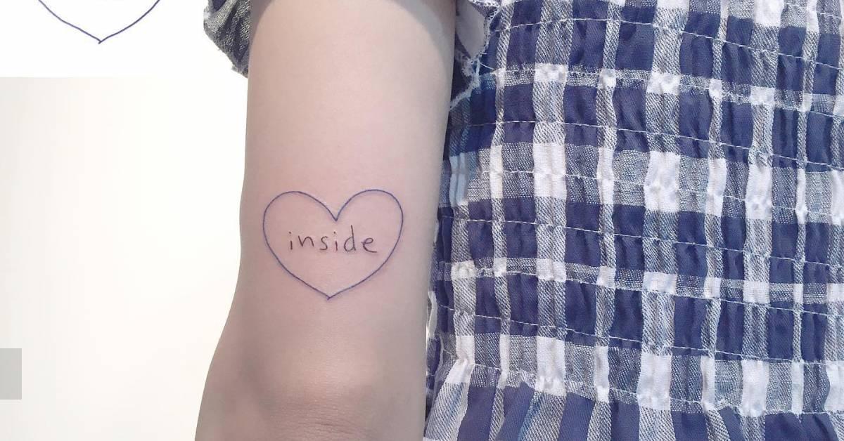 Minimalistic heart and word "Inside" tattooed on the