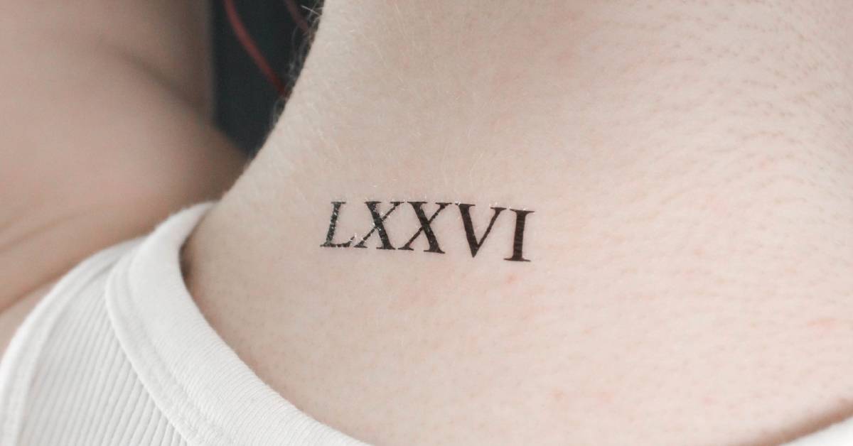 "LXXVI" roman numerals temporary tattoo located on the