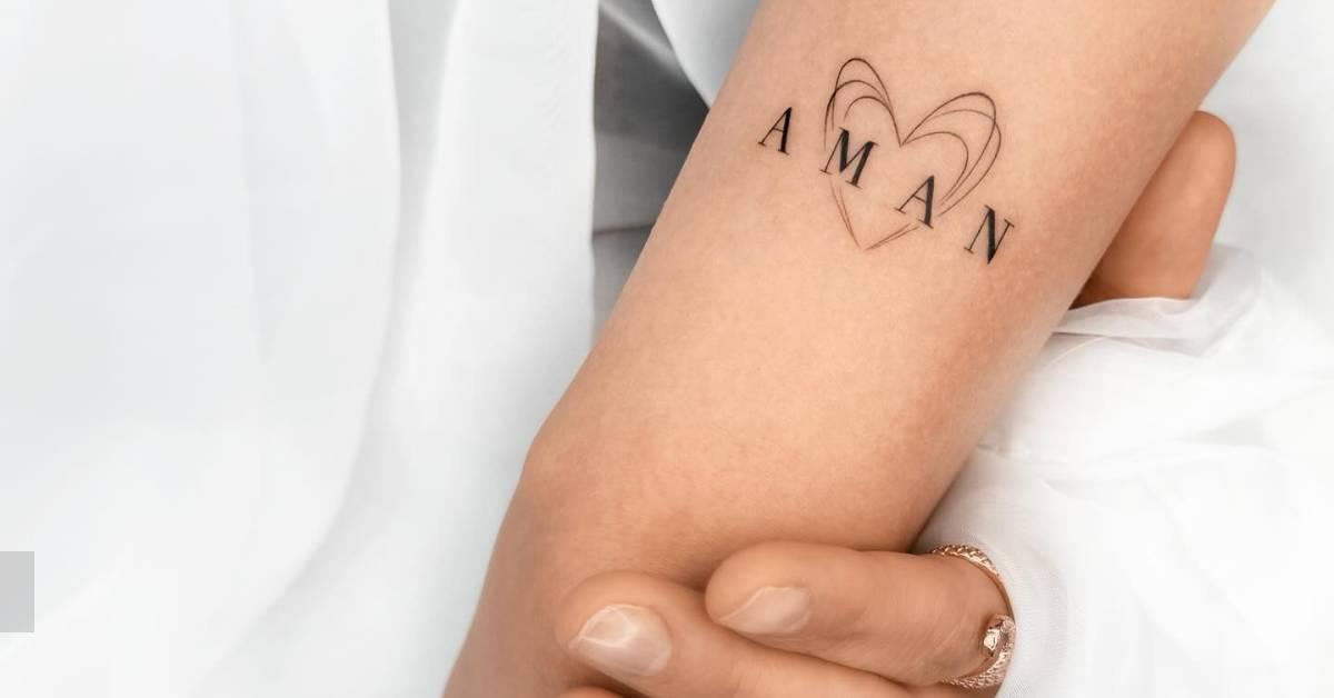 Tattoo of the name "Aman" and hearts located on the
