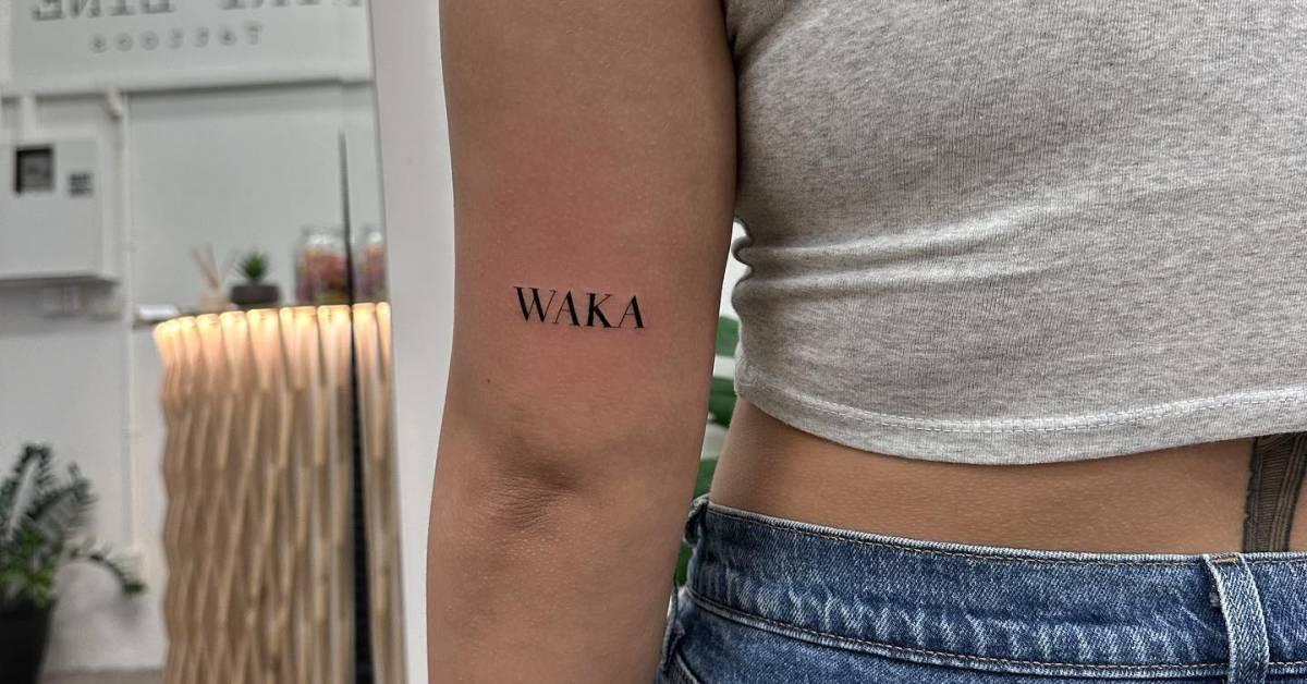 Tattoo of the word "waka" located on the tricep.