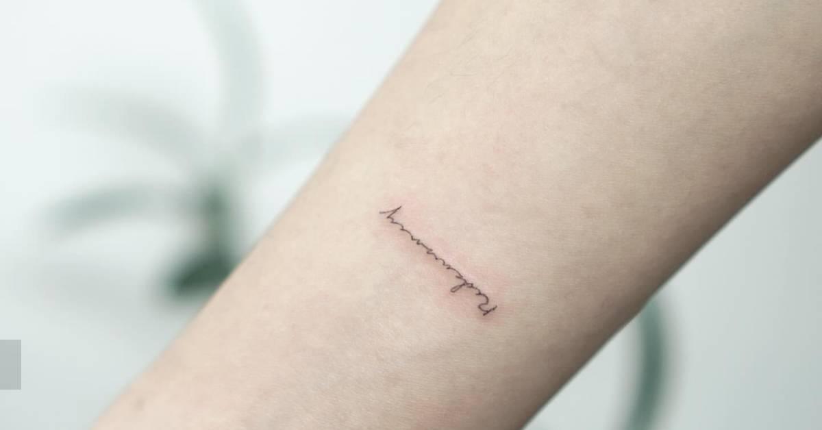 Handwritten lettering tattoo done on the wrist.