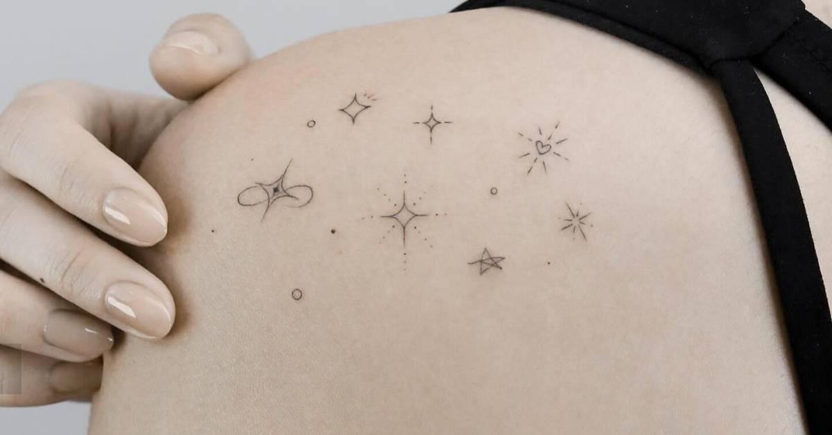 Fine line style stars tattoo located on the shoulder