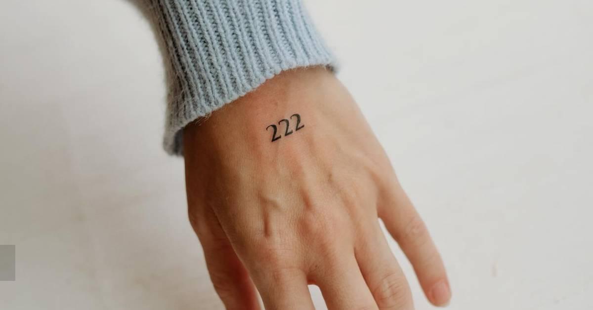 Lettering tattoo of the number "222" located on the