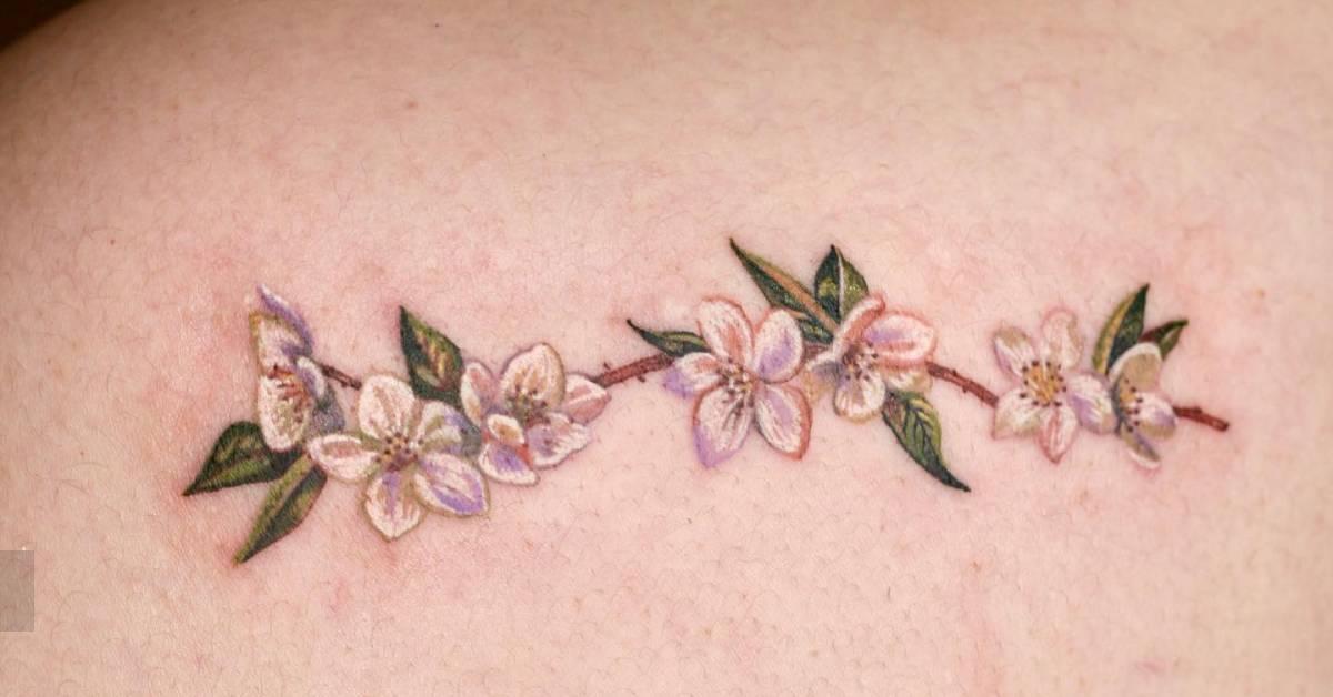 Pear blossom tattoo located on the shoulder blade,