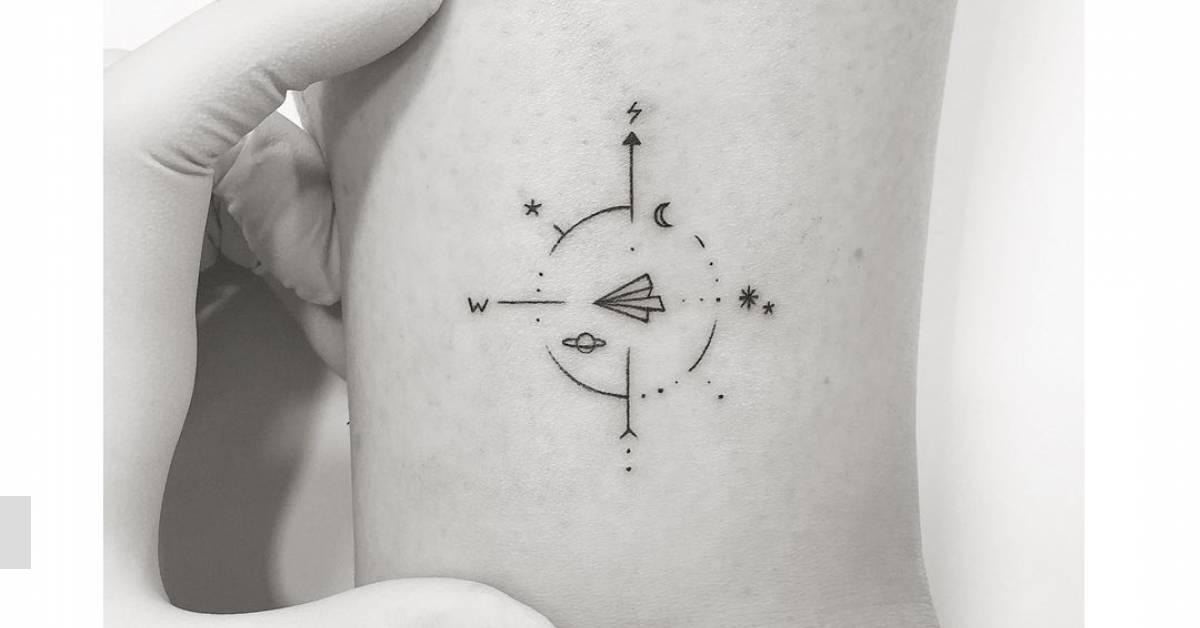 Compass rose and paper plane tattoo done on the ankle.