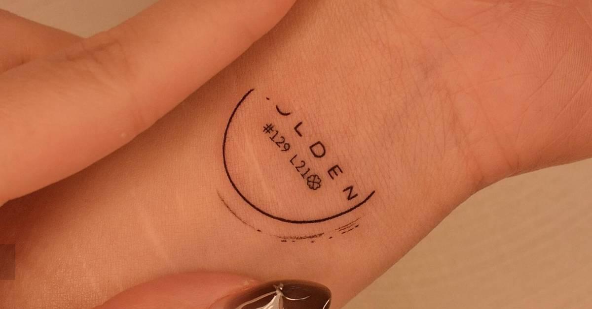 Travel stamp tattoo located on the wrist.