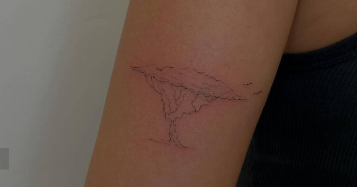 Fine line style acacia tree tattoo located on the