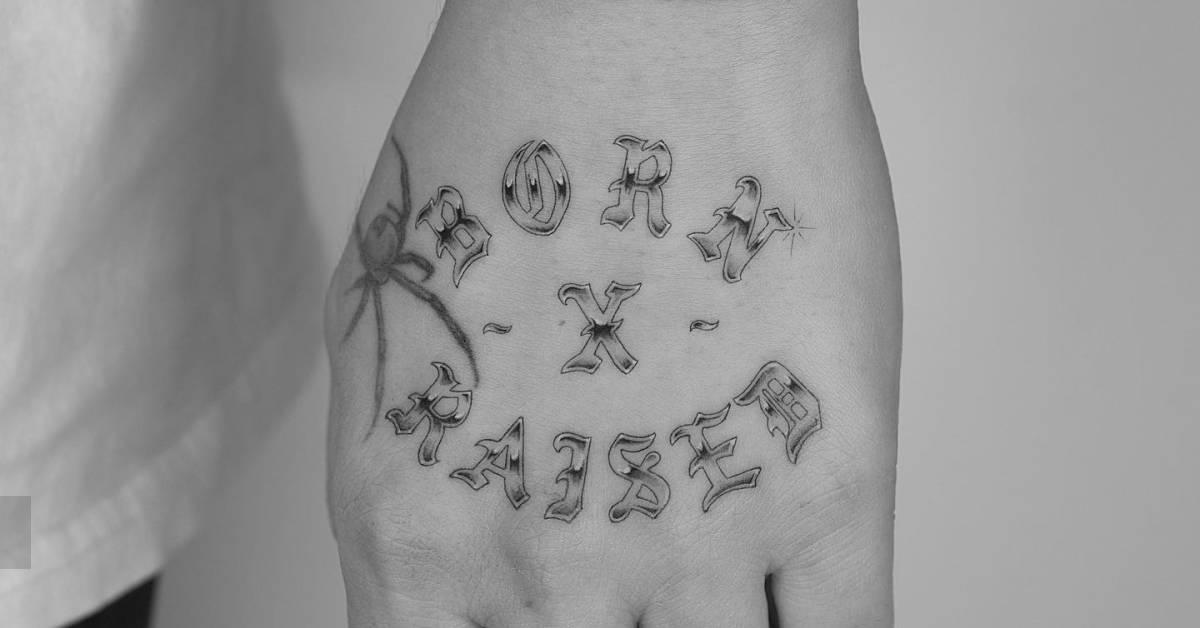 Born X Raised tattoo located on the hand.