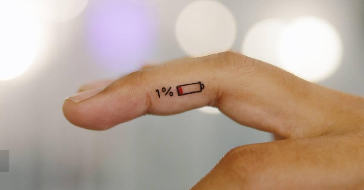 Minimalistic style battery icon tattoo located on the