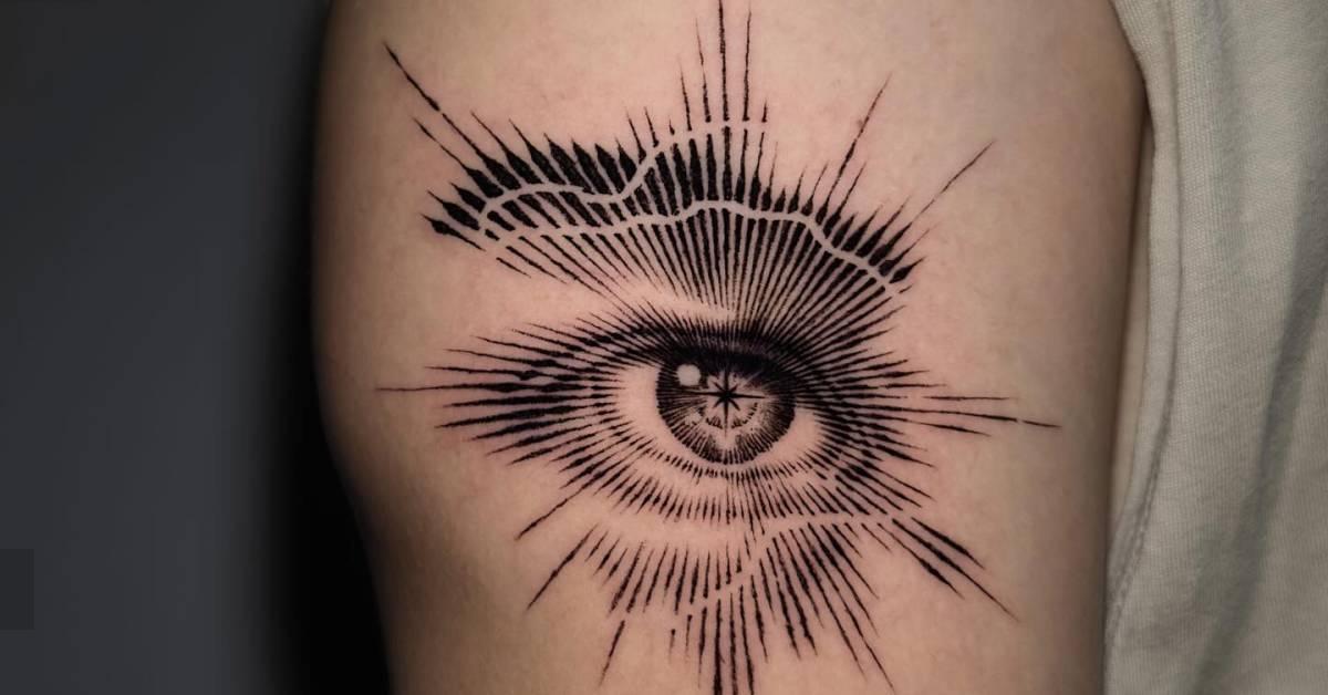 Eye tattoo placed on the upper arm, done in blackwork