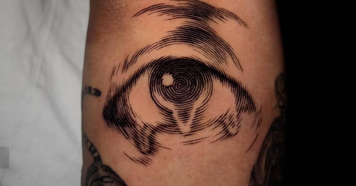 Engraving tattoo of an eye located on the forearm.