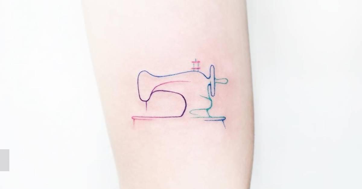 Spectrum sewing machine tattoo done on the inner arm.