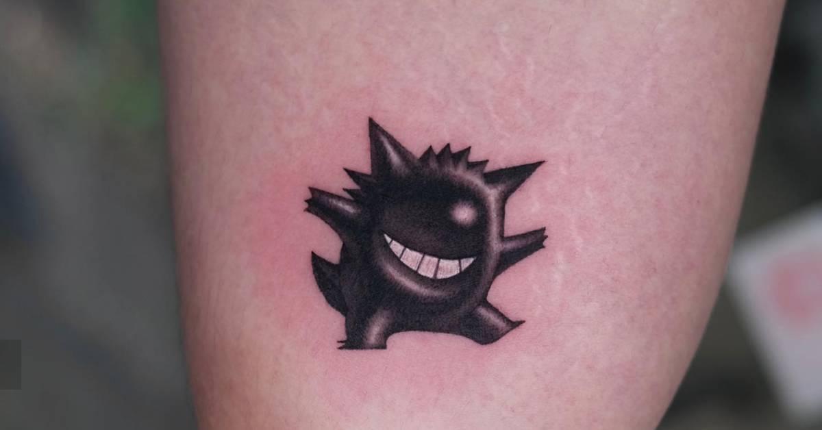 Cartoon style Gengar tattoo located on the inner arm.
