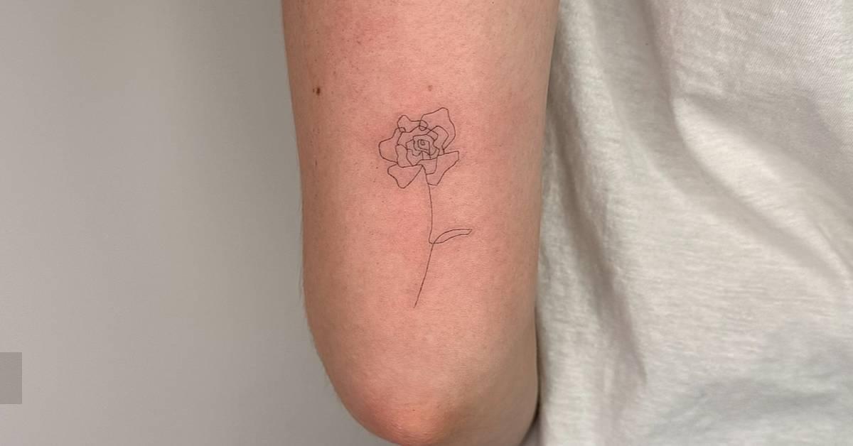 One line rose tattoo located on the tricep.