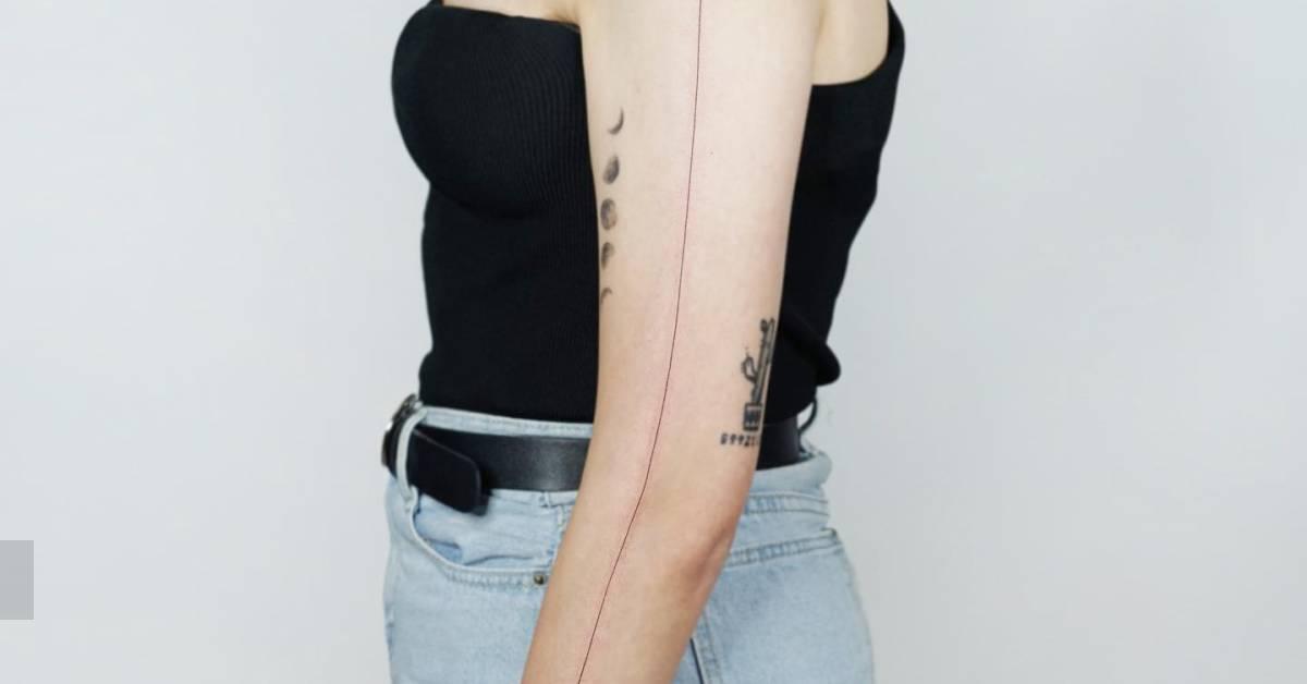 Minimalistic style line tattoo located on the neck and