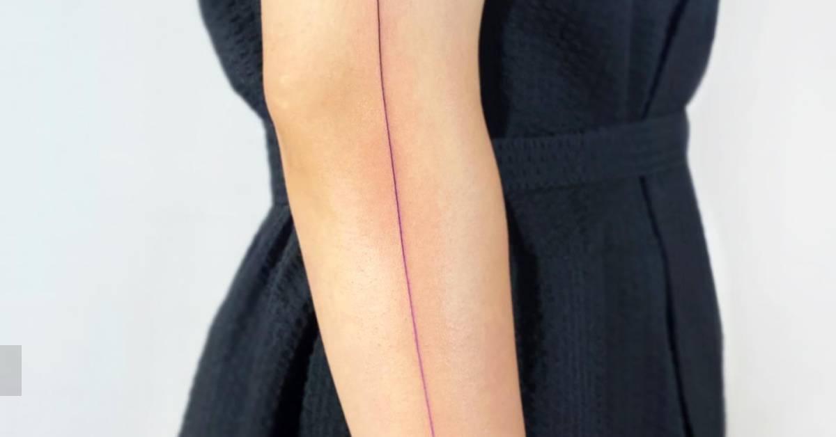 Line tattoo located on the arm, minimalistic style.