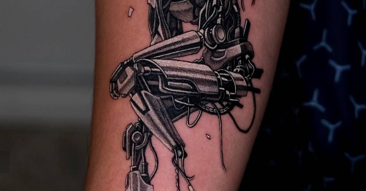 Comic style humanoid robot tattoo located on the inner