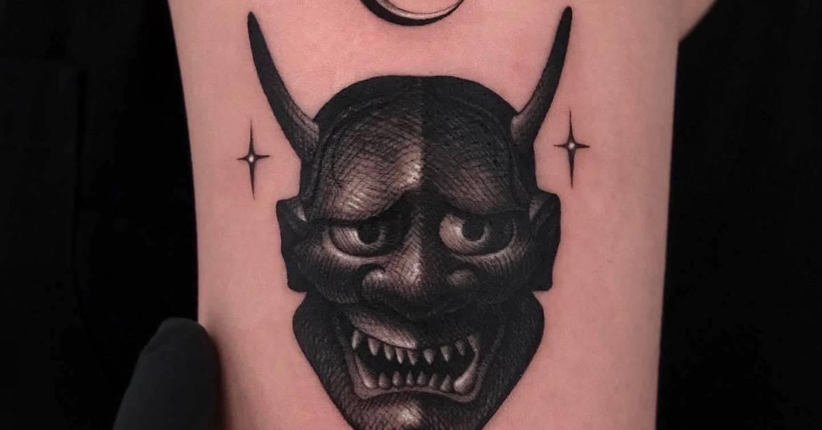Illustrative style Hannya mask tattoo located on the