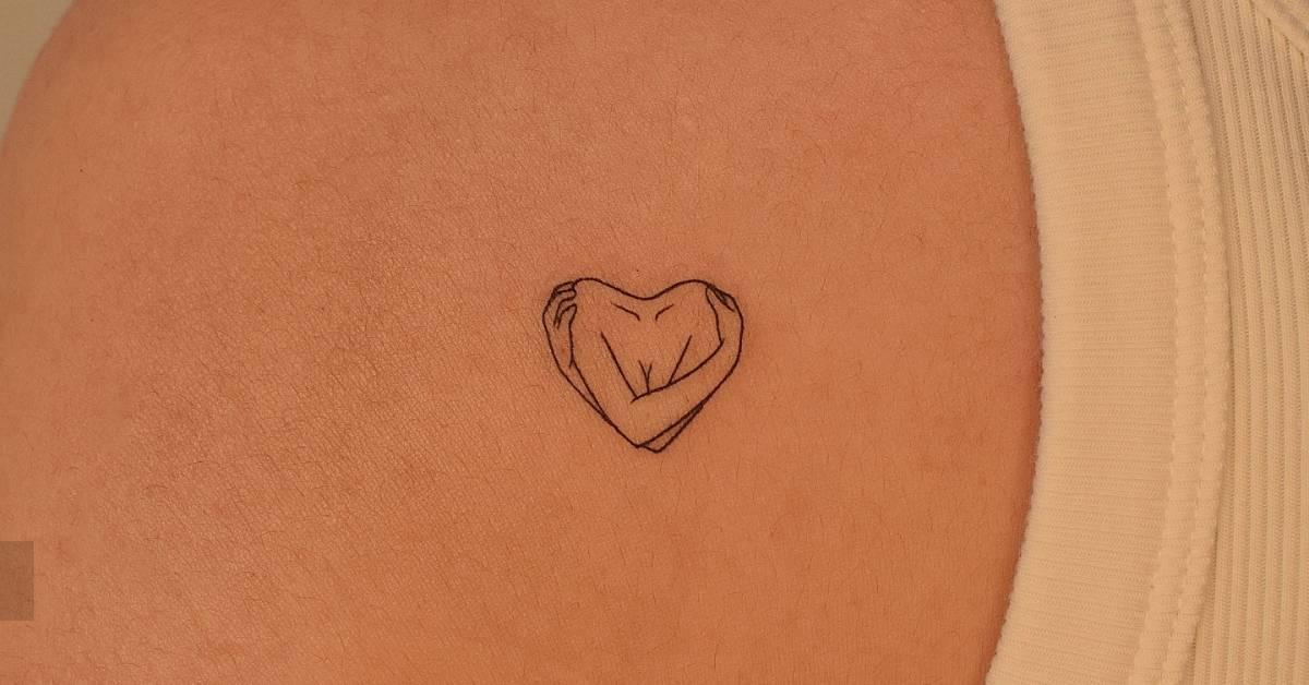 Fine line style self hug tattoo placed on the shoulder