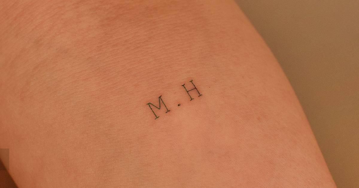 Initials tattoo located on the inner forearm,