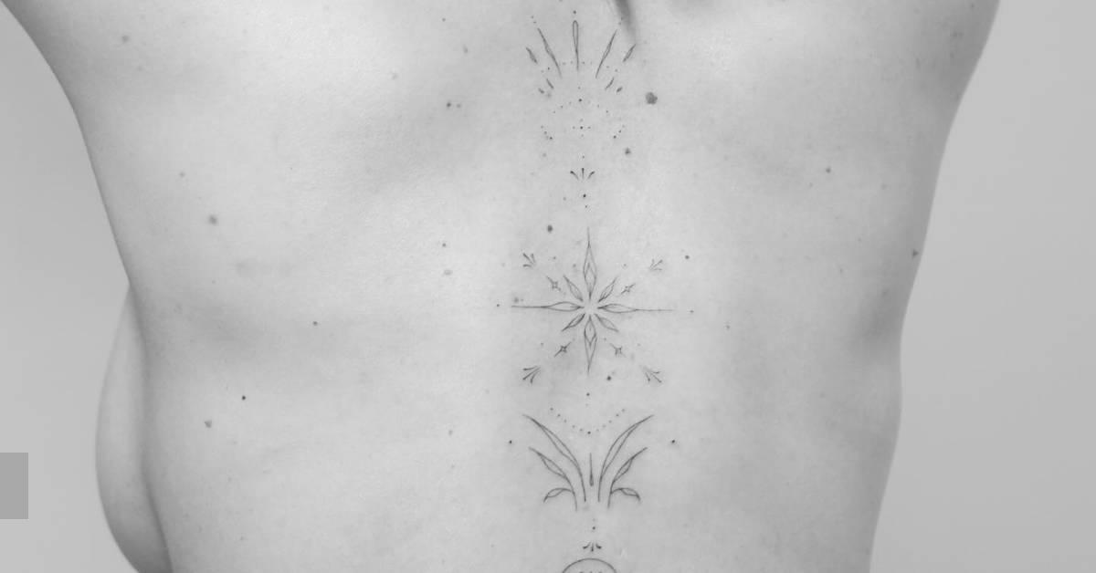 Fine line style ornamental back composition tattoo