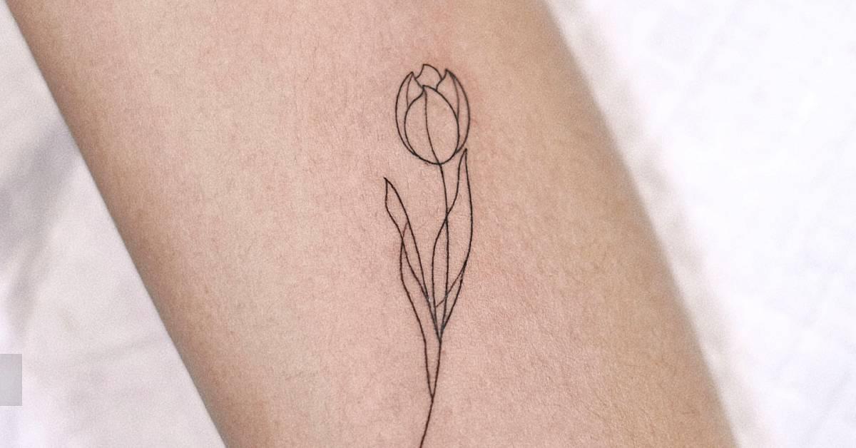 Cute fine line tulip tattoo located on the inner