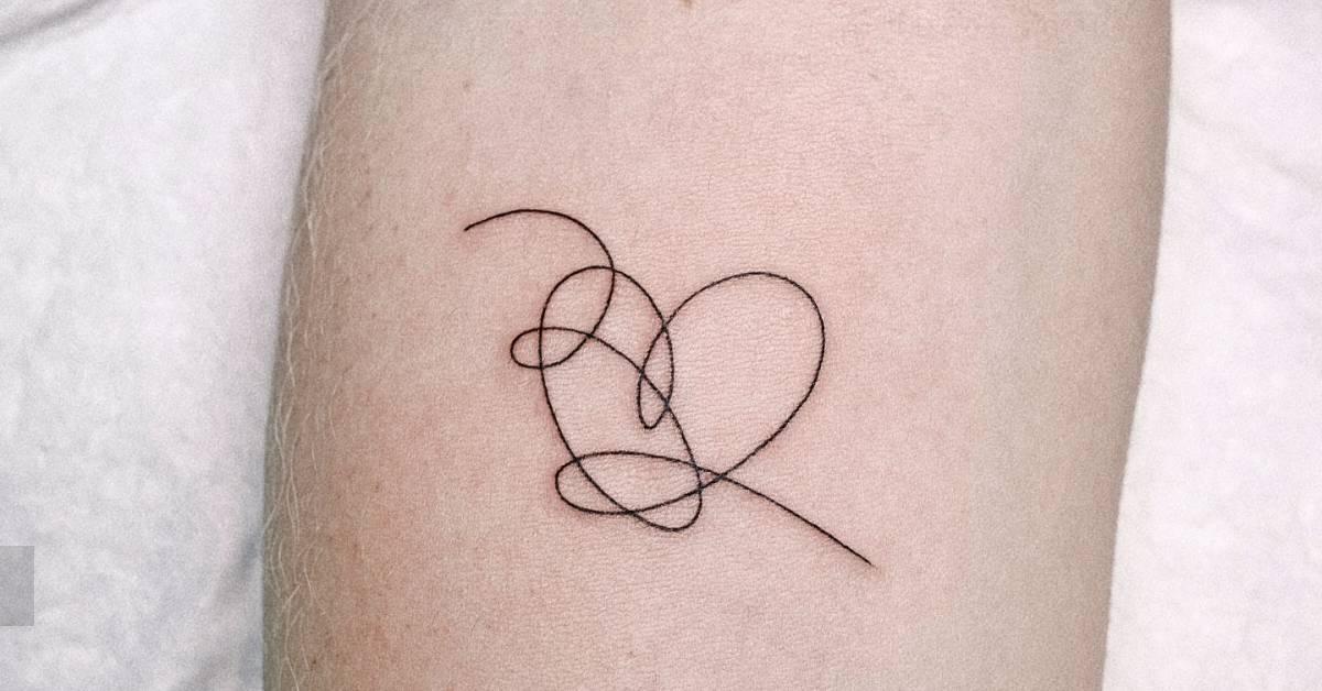 BTS heart tattoo located on the inner forearm.