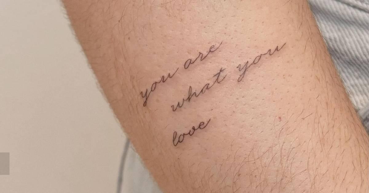 "You are what you love" lettering tattoo located on the