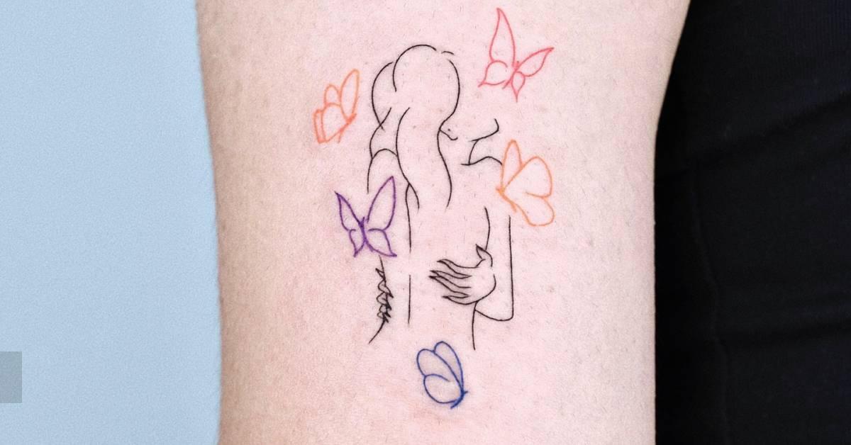 Hug and butterflies tattoo located on the tricep, fine