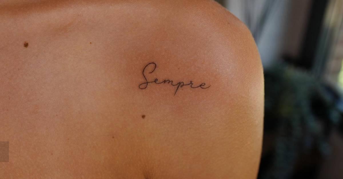 Tattoo of the word "sempre" located on the shoulder.