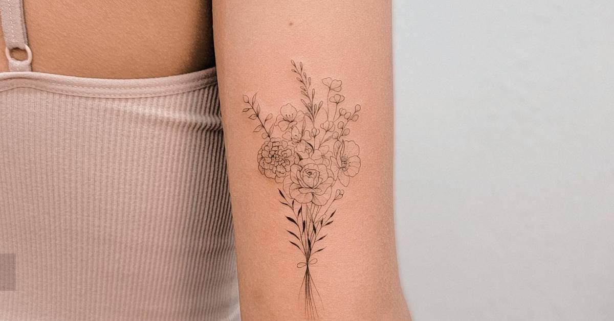 Fine line style flower bouquet tattoo located on the