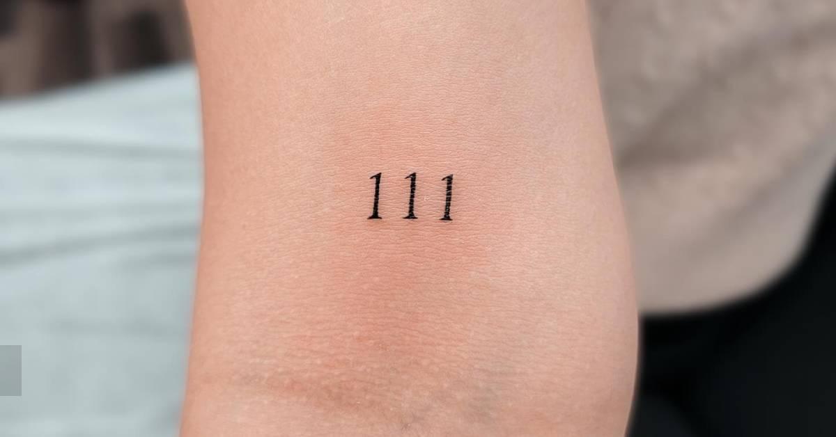 Angel number "111" lettering tattoo located on the