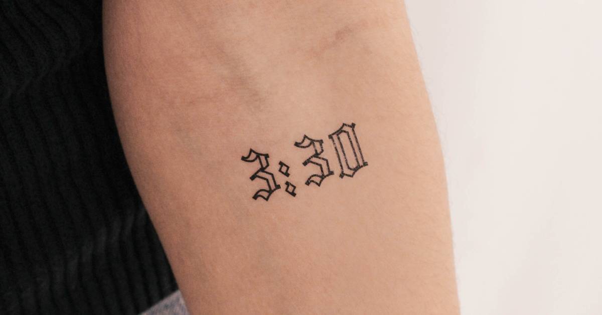 "3:30" temporary tattoo located on the inner forearm.