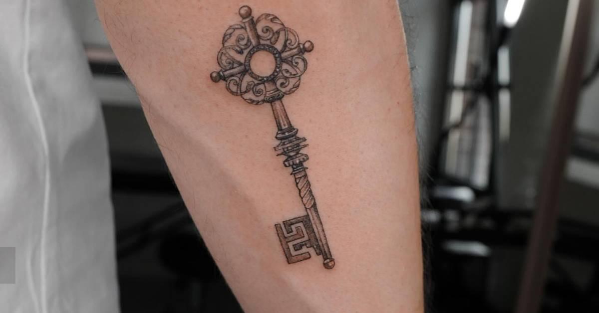 Key tattoo done on the forearm, illustrative style.
