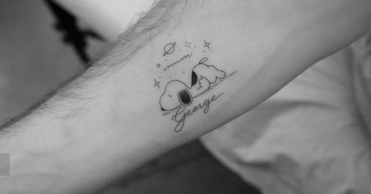 Snoopy tattoo located on the inner forearm, cartoon