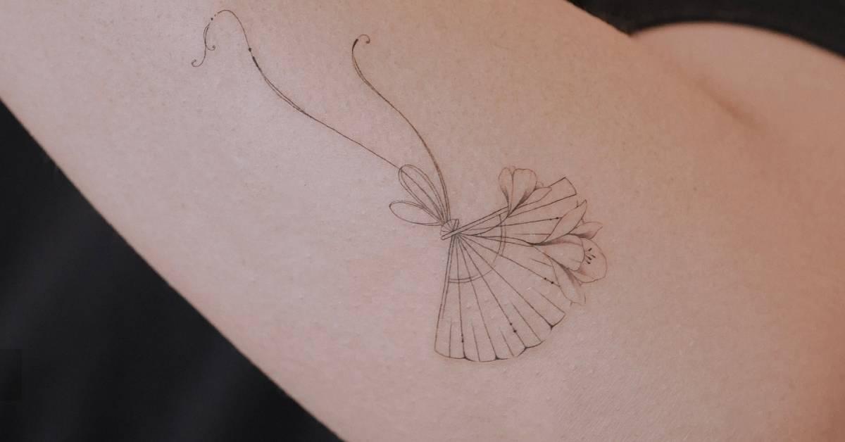 Hand fan tattoo in fine line style located on the
