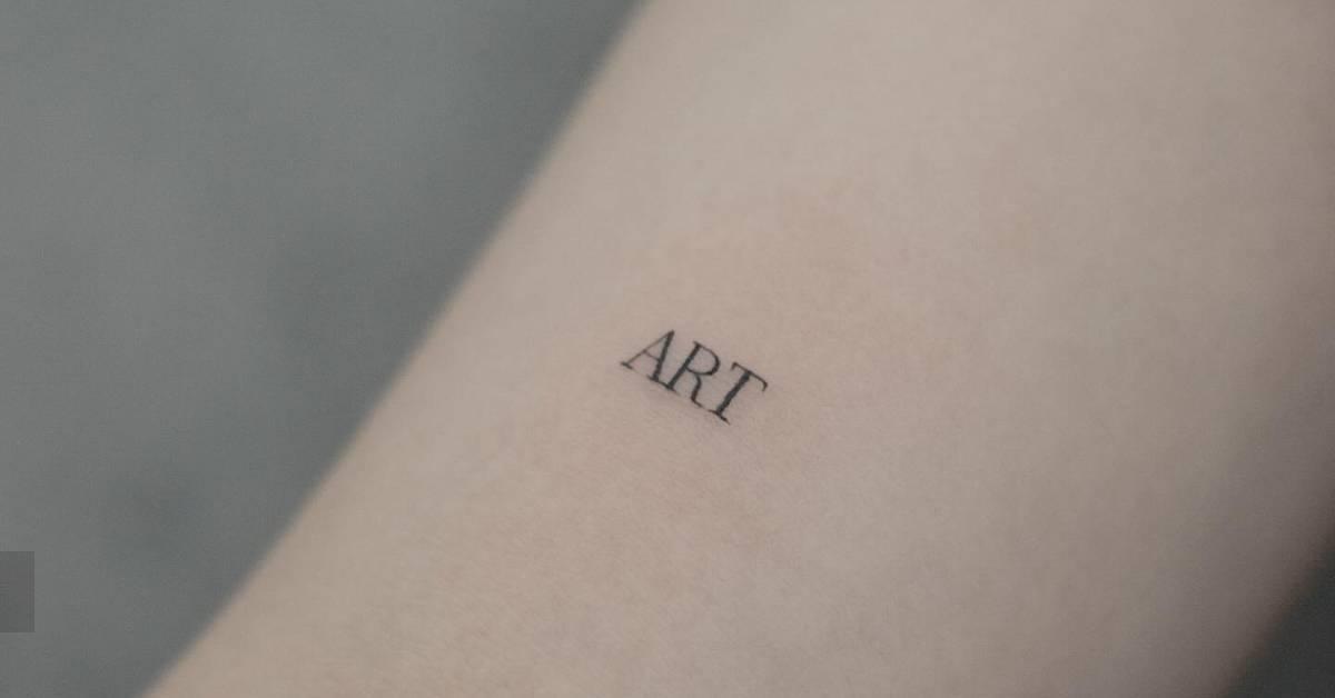 Lettering tattoo of the word "art" located on the