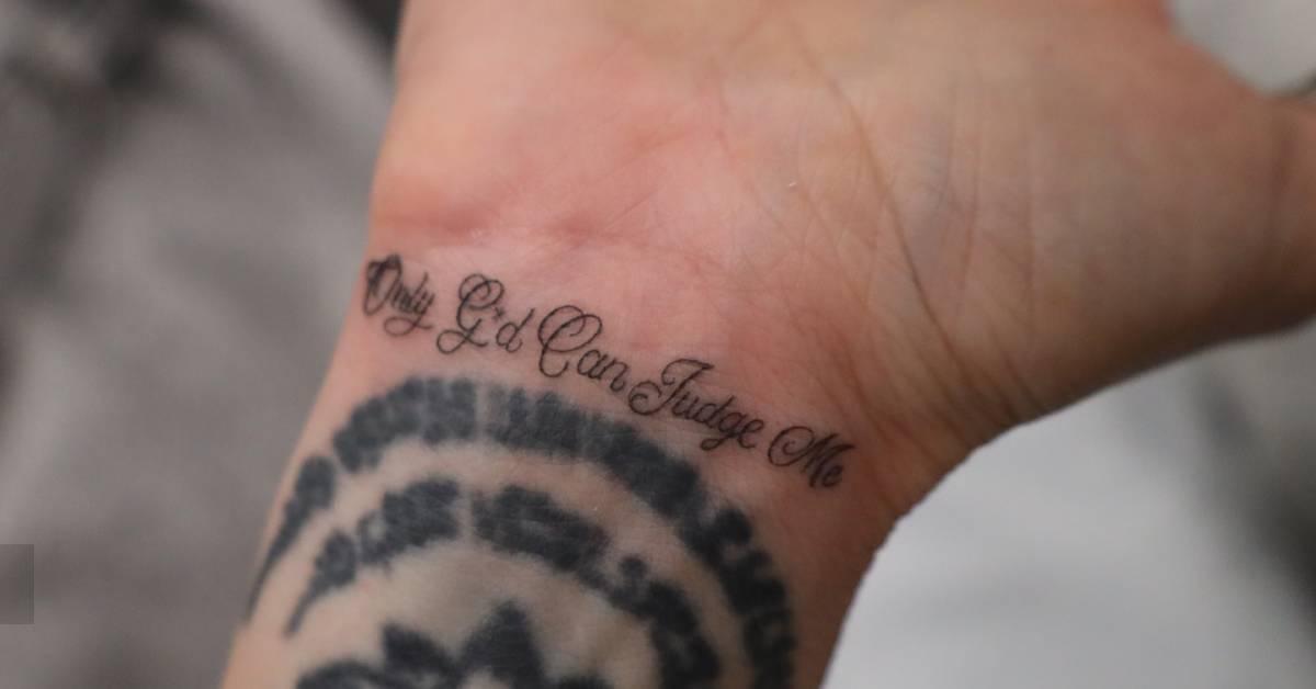 "Only God can judge me" lettering tattoo placed on the
